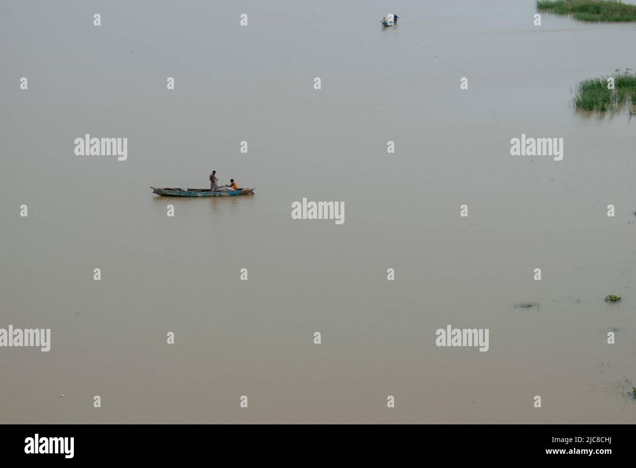 Small fishing Boat in the middle of water Stock Photo - Alamy