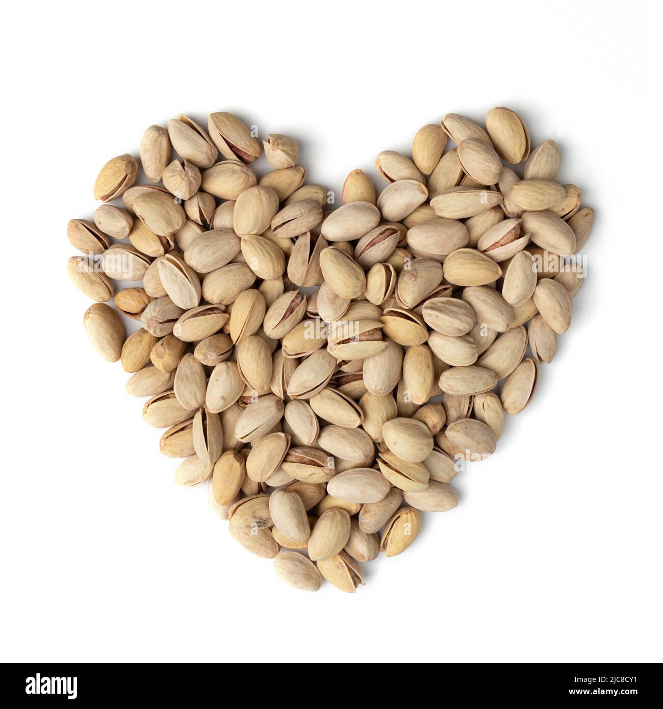 heart of unpeeled pistachio isolated on white background, concept ...