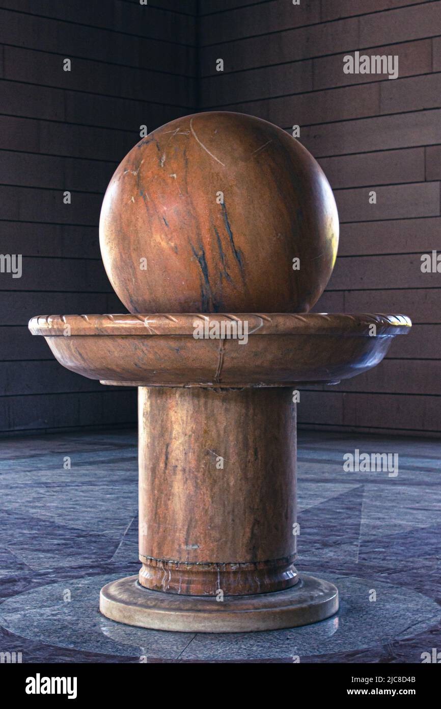 A sphere made of marble. A single column fountain Stock Photo - Alamy