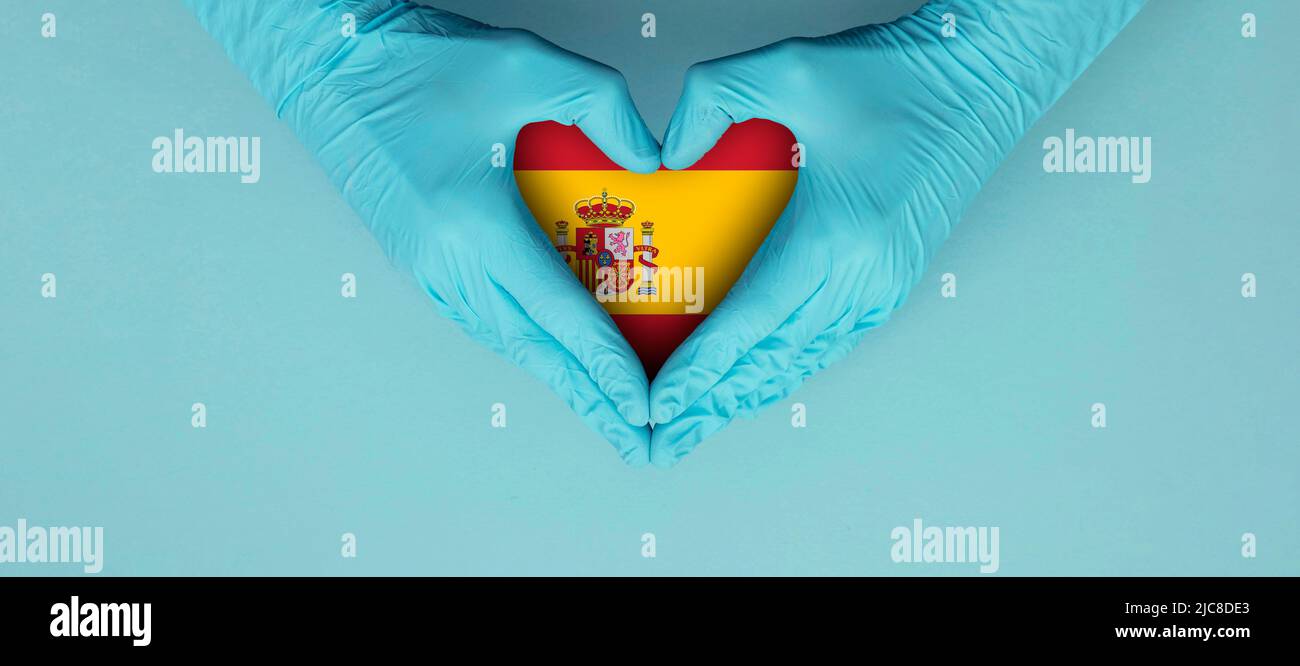 Doctors hands wearing blue surgical gloves making hear shape symbol ...