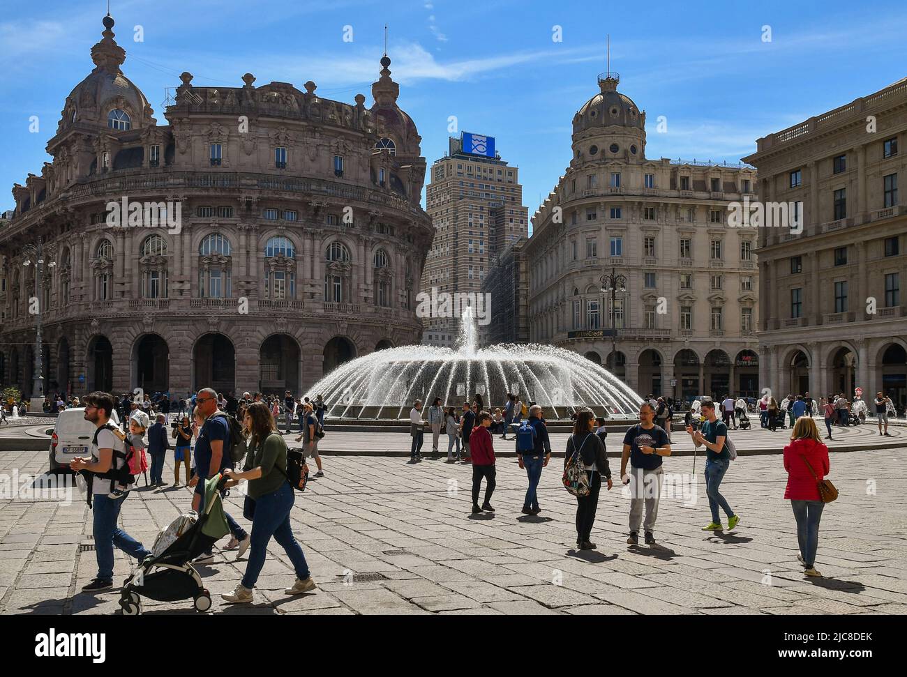 Tourists in Piazza De Ferrari, one of the main square of Genoa, with ...