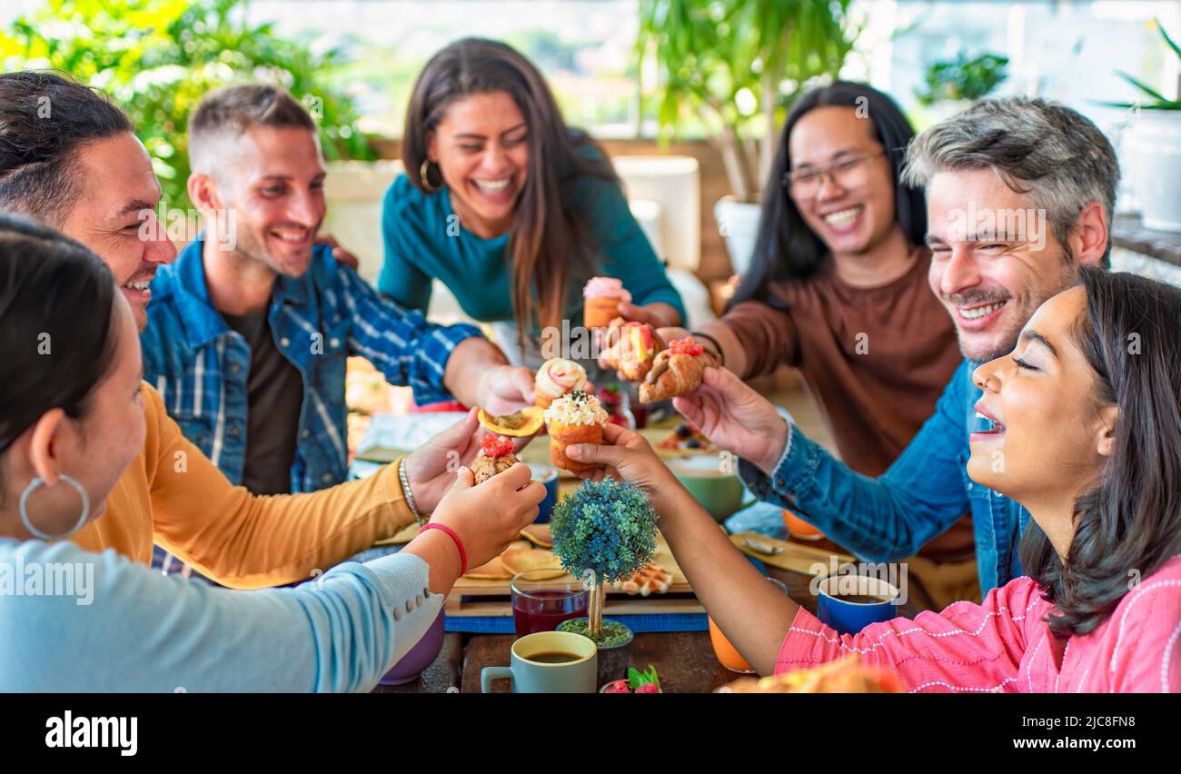 multiethnic large group of friends sitting on cafe table restaurant ...