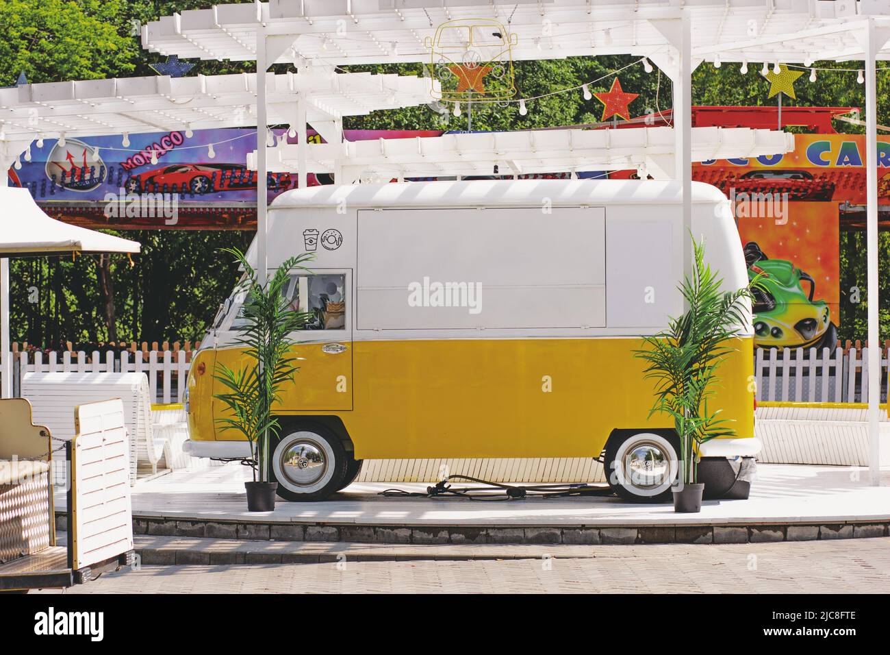 Yellow and white retro car as food truck Stock Photo - Alamy