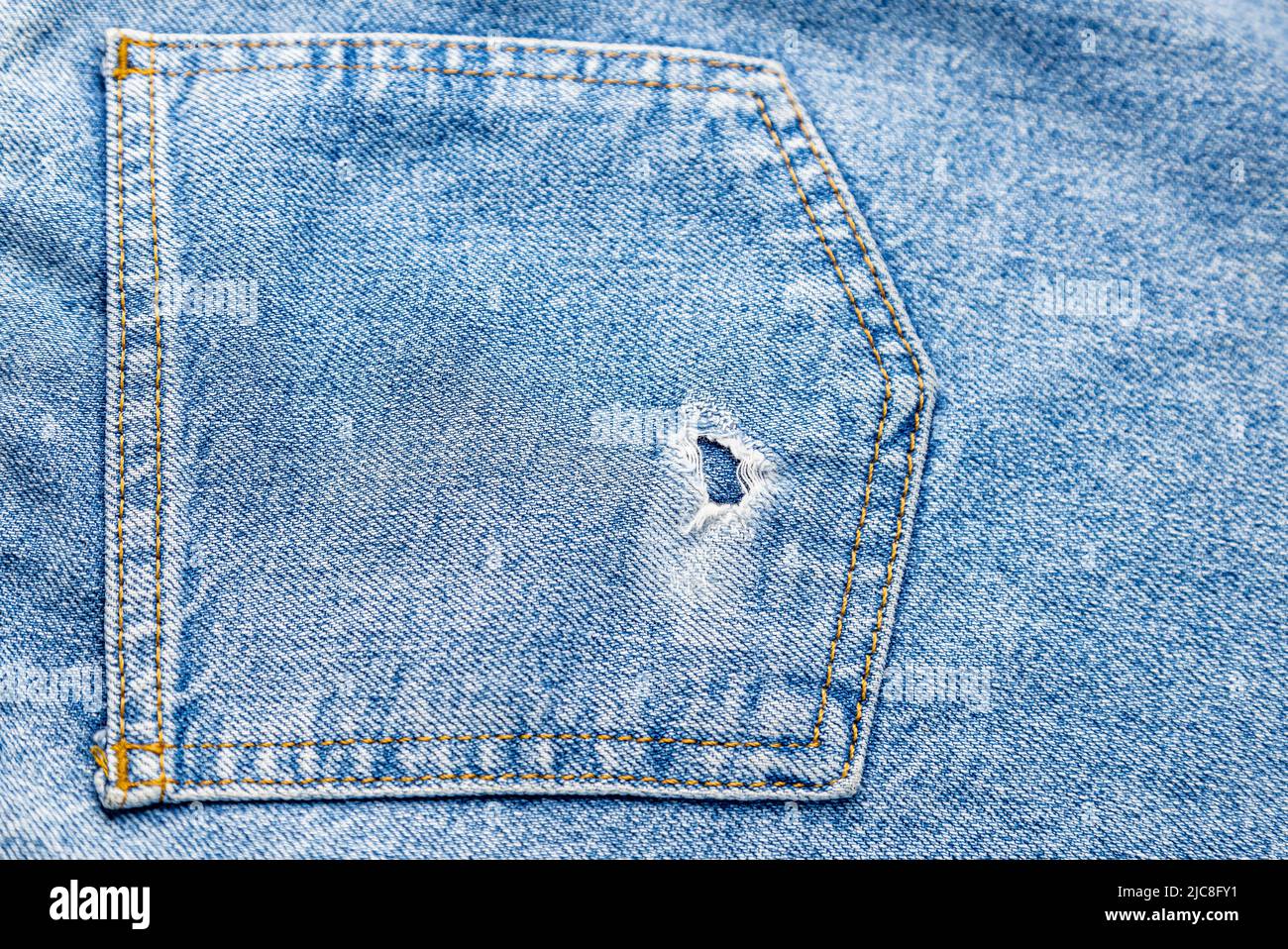 Denim texture. Back torn pocket of blue jeans close up Stock Photo - Alamy