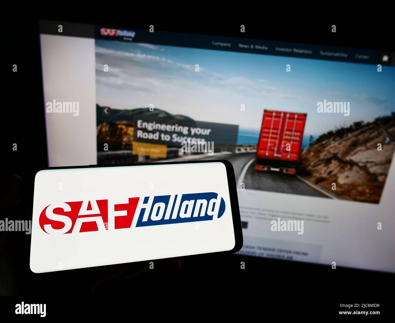 Person holding smartphone with logo of German automotive company SAF ...