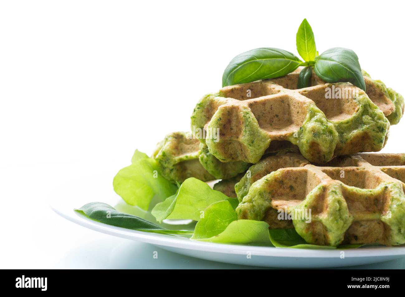 vegetable waffles cooked with herbs in a plate isolated on white ...