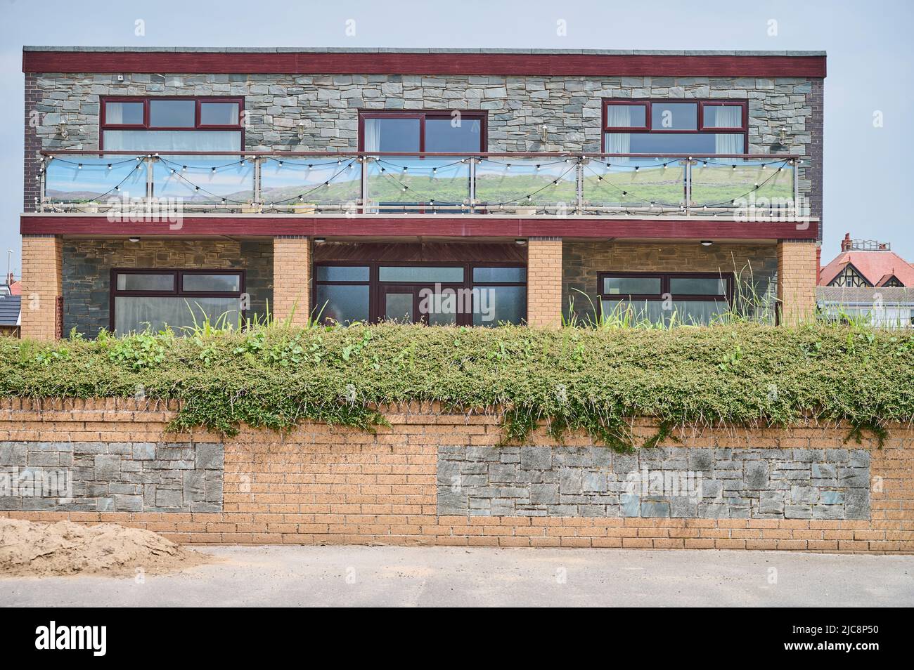 Detached house with upper balcony panels depicting mountains scene ...