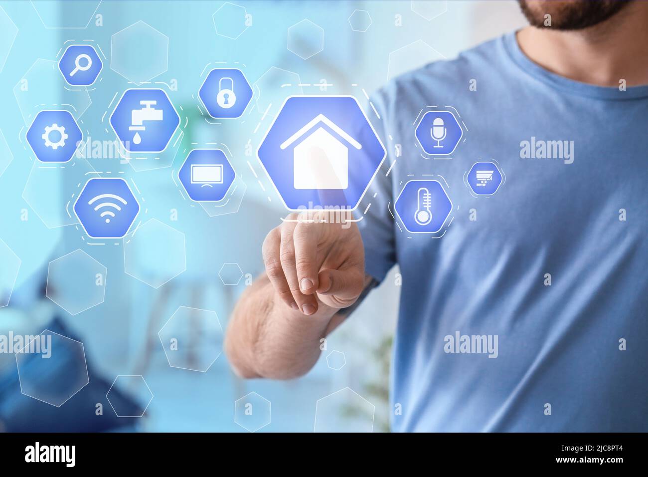 Man using application of smart home automation in room Stock Photo - Alamy