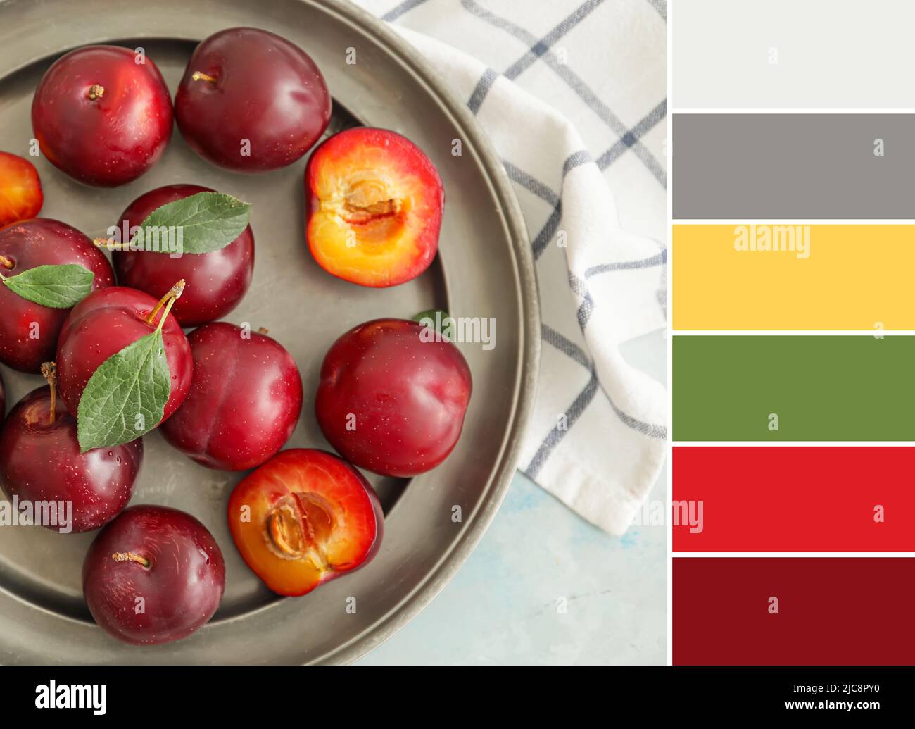 Plate of fresh ripe plums on table, top view. Different color patterns ...