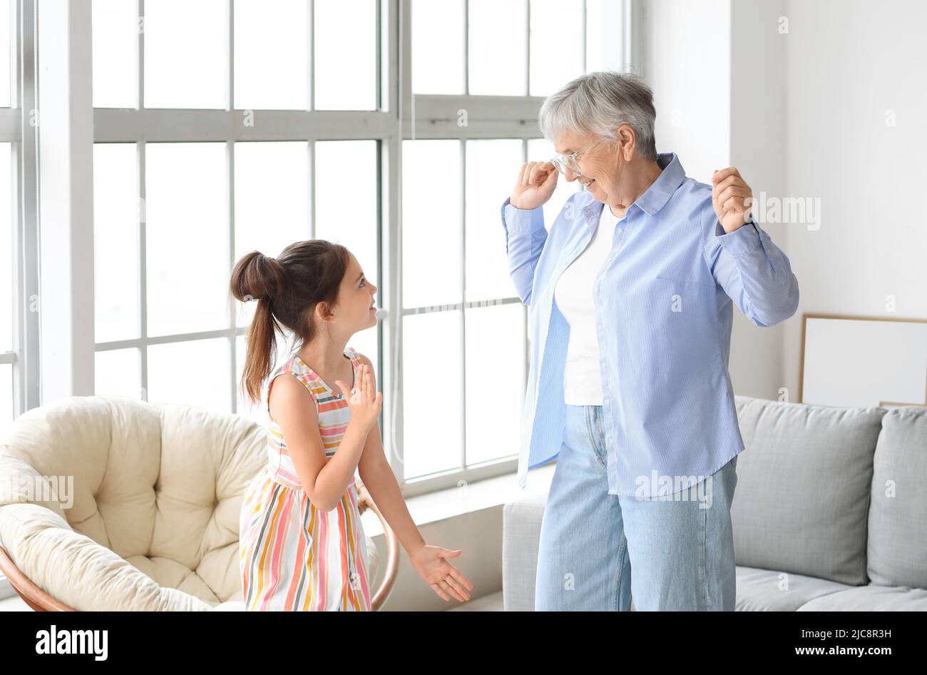 Little girl with her grandma dancing at home Stock Photo - Alamy