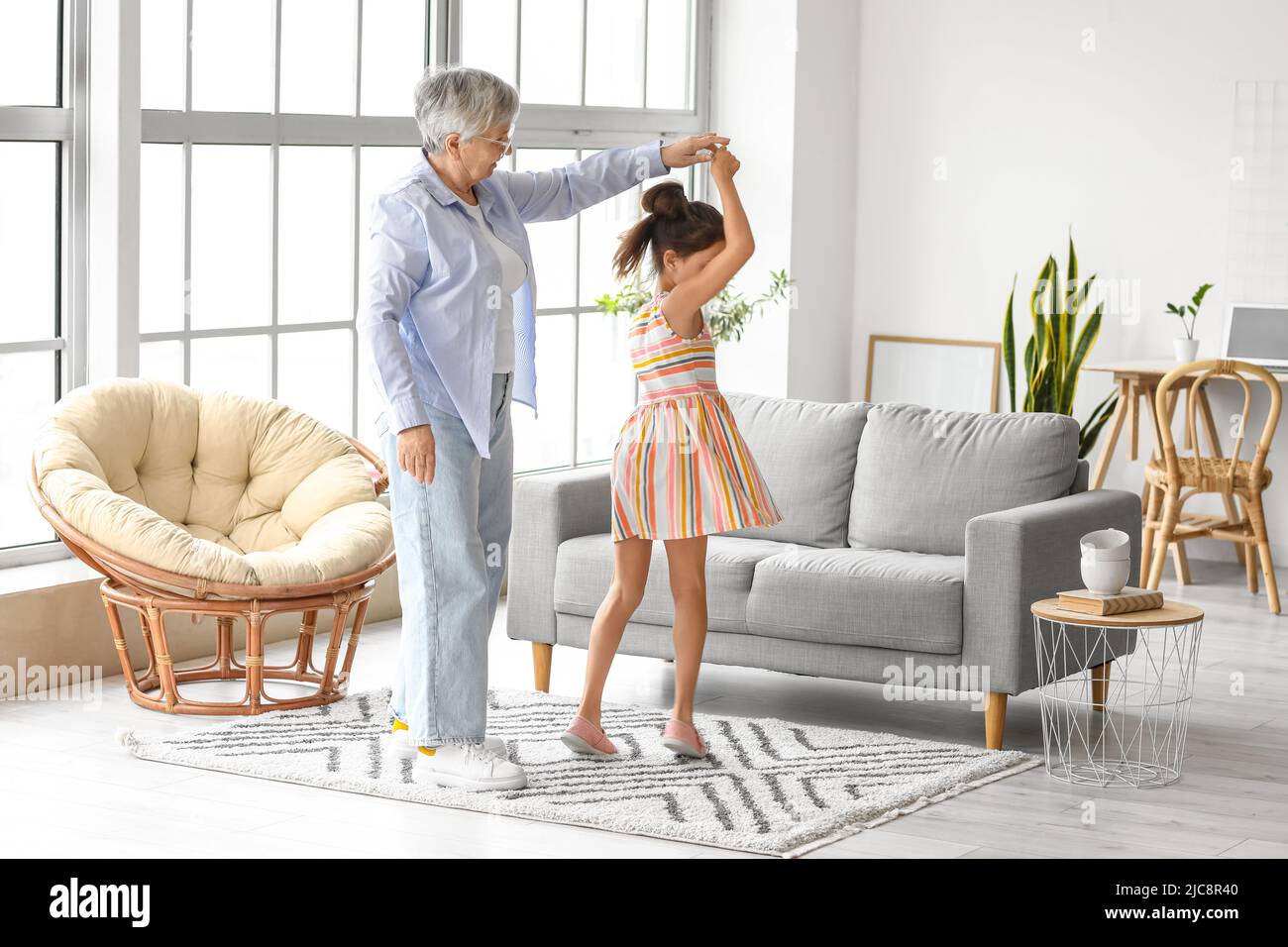 Little girl with her grandma dancing at home Stock Photo - Alamy