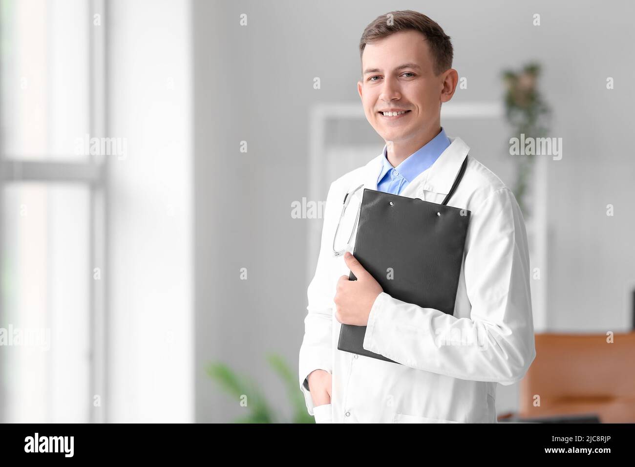 Male medical assistant with clipboard at hospital Stock Photo - Alamy