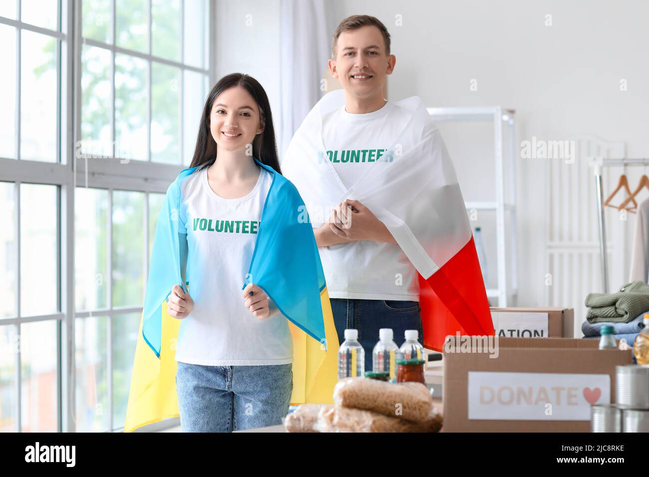 Volunteers with flags of Ukraine and Poland in center Stock Photo - Alamy