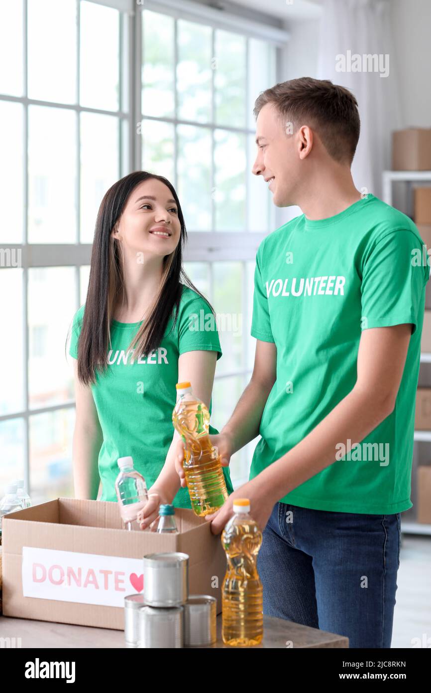 Polish volunteers putting bottles of sunflower oil and water into ...