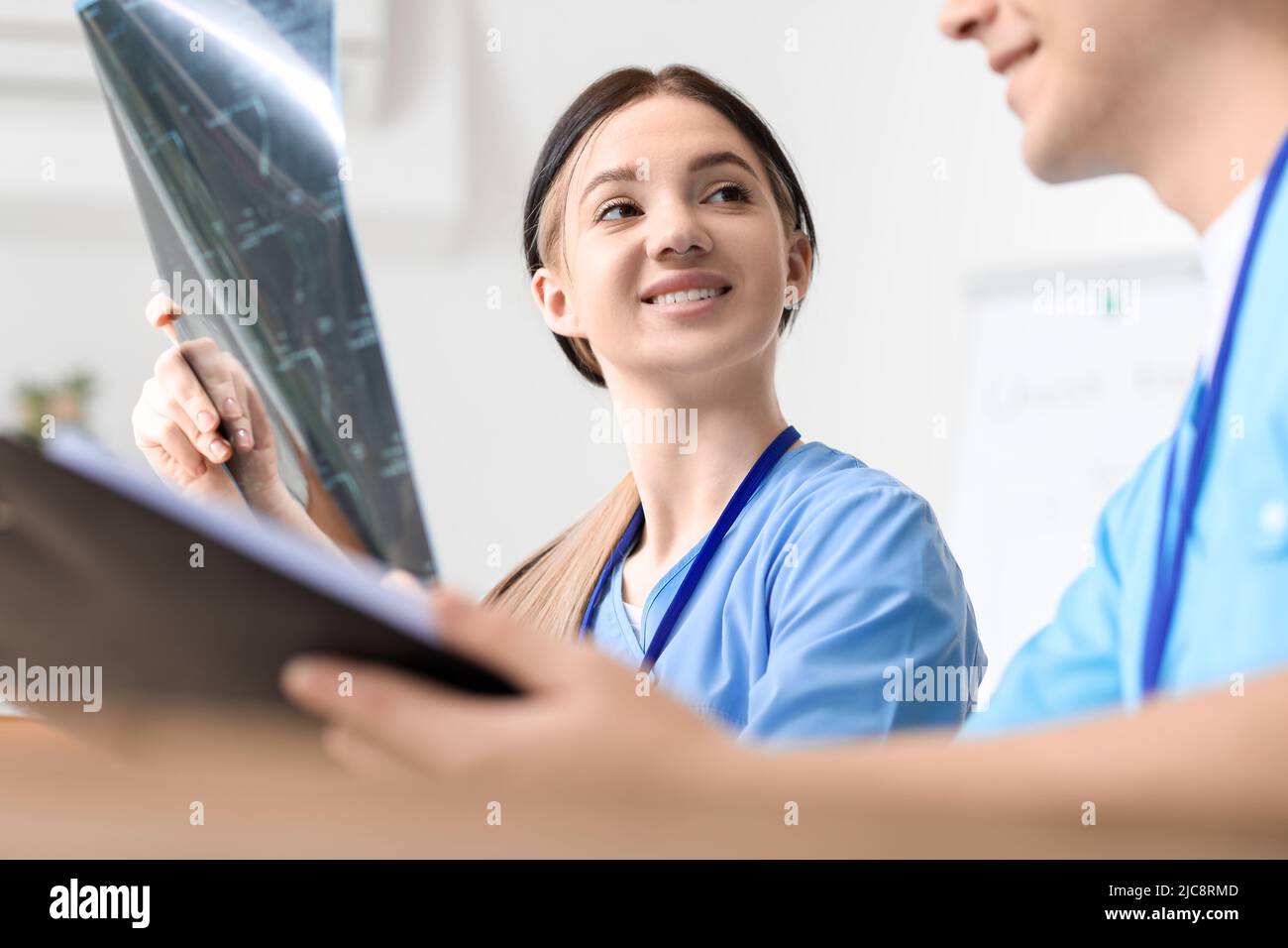 Female medical assistant working with x-ray scan in clinic Stock Photo ...