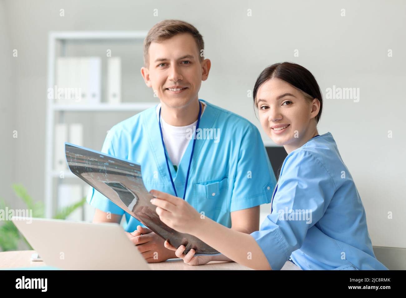 Medical assistants studying x-ray scan in clinic Stock Photo - Alamy