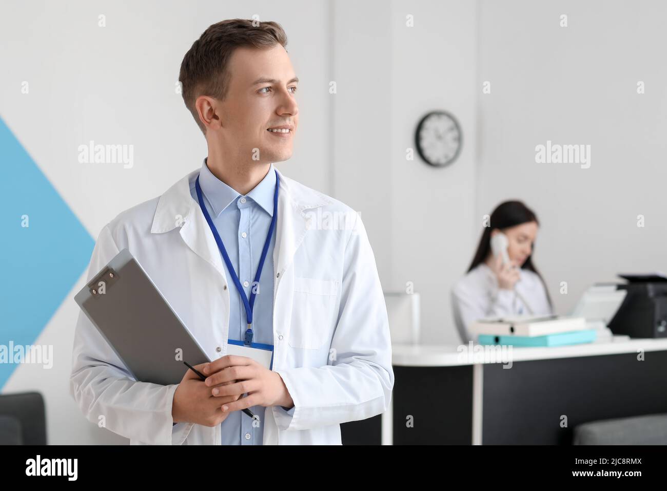 Male medical assistant with clipboard at hospital Stock Photo - Alamy
