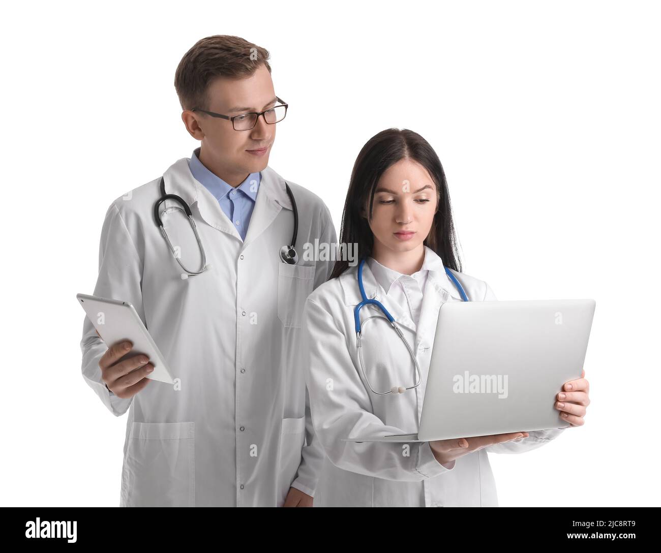 Medical assistants with laptop and tablet computer on white background ...
