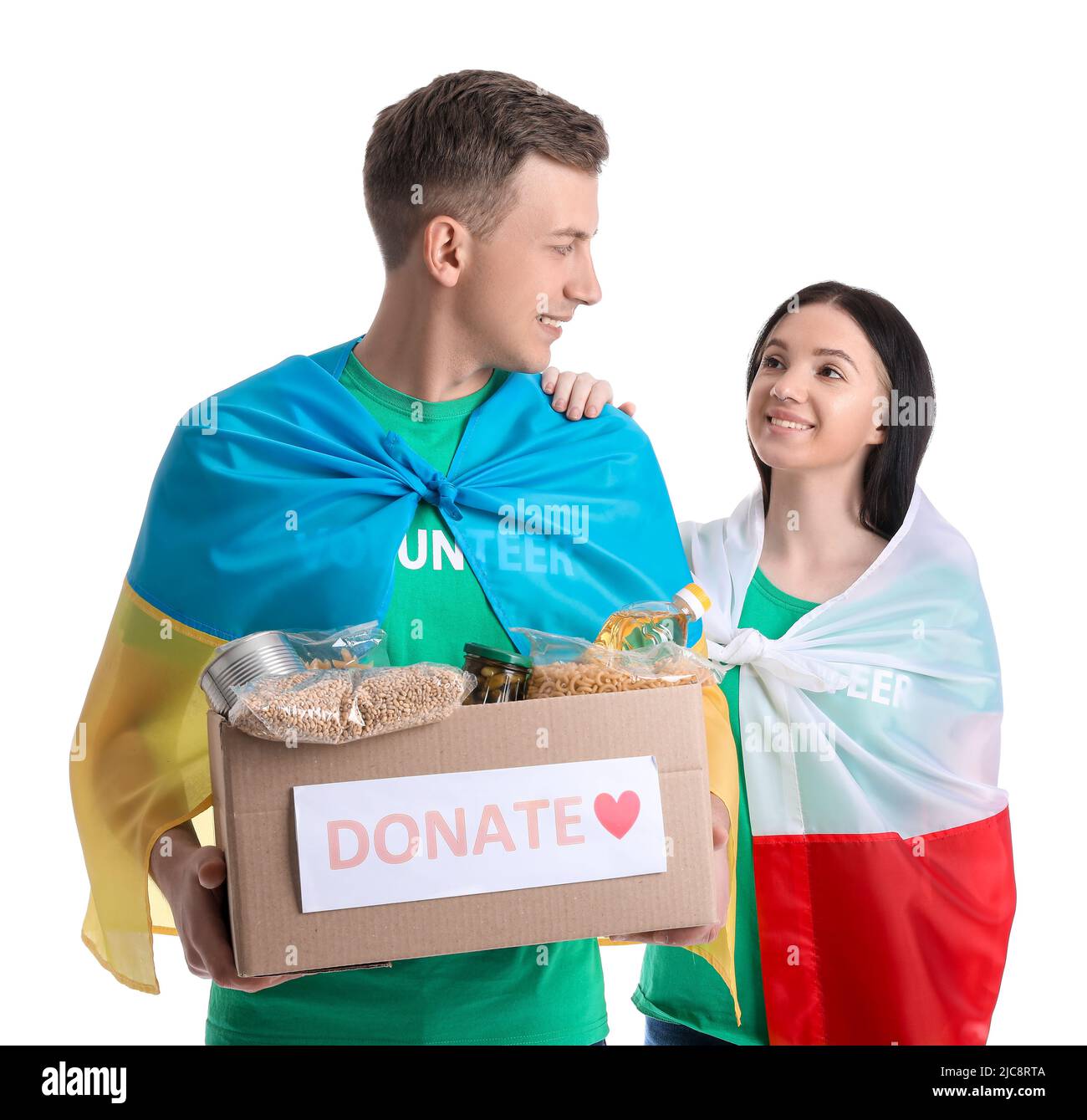 Volunteers with flags of Ukraine, Poland and donation box on white ...