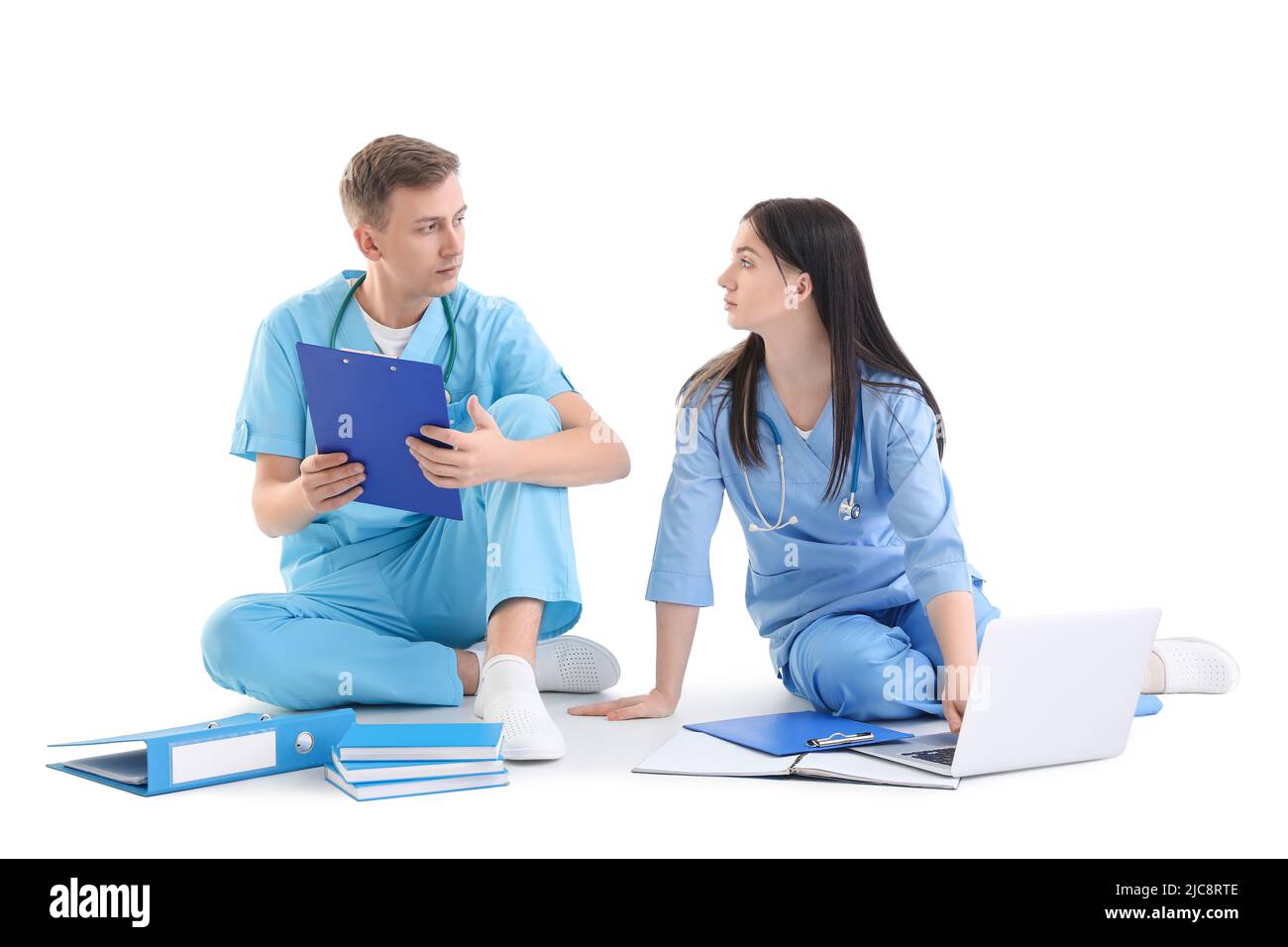 Medical assistants with clipboard on white background Stock Photo - Alamy