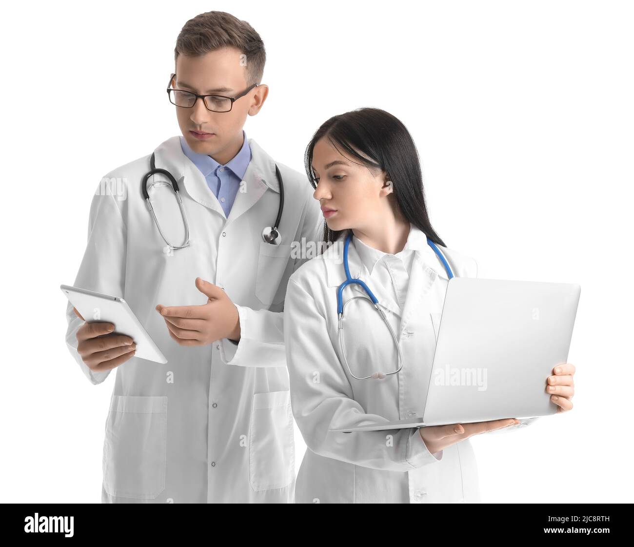 Medical assistants with laptop and tablet computer on white background ...