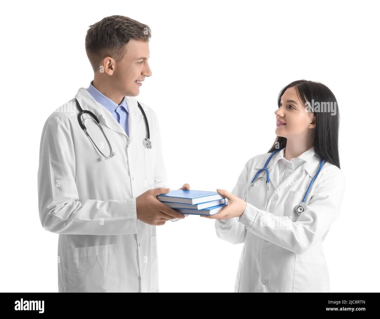 Medical assistants with books on white background Stock Photo - Alamy