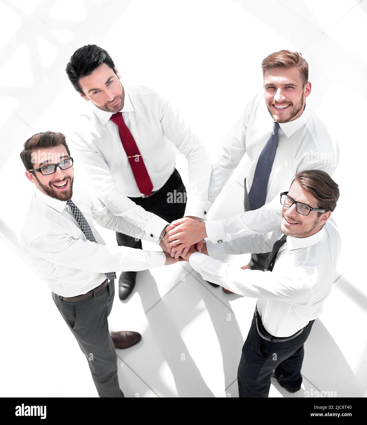 Team members putting hands hi-res stock photography and images - Alamy