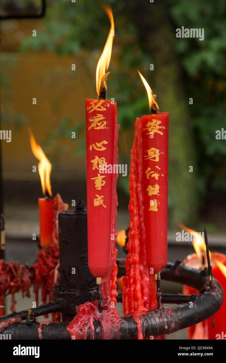 Votive candles with Chinese characters burning in the Arhat Hall of the ...