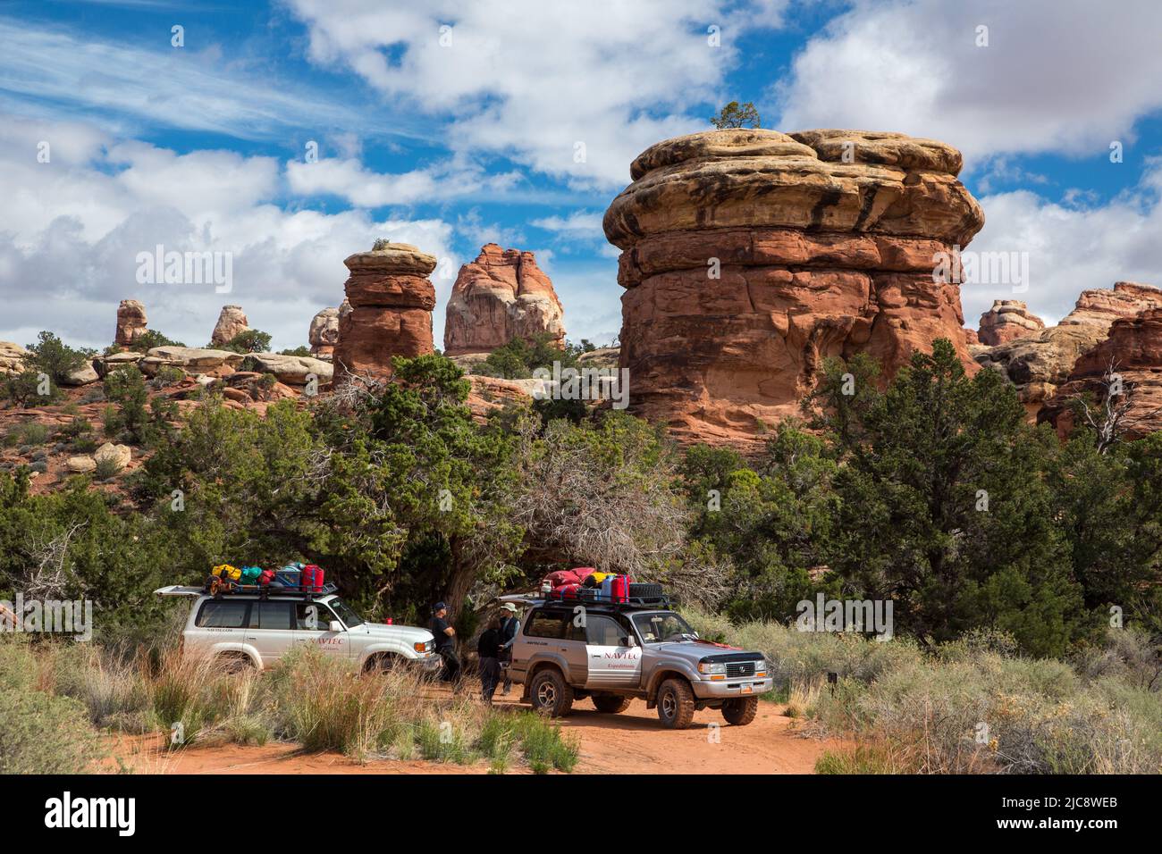 Two 4wd SUV tour vehicles stop for a break in the Maze District of ...