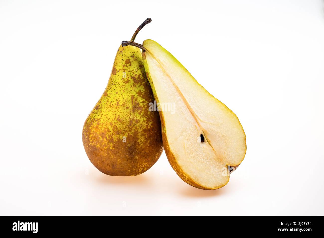 Fresh pears, whole and half. Yellow green fruit isolated on white ...