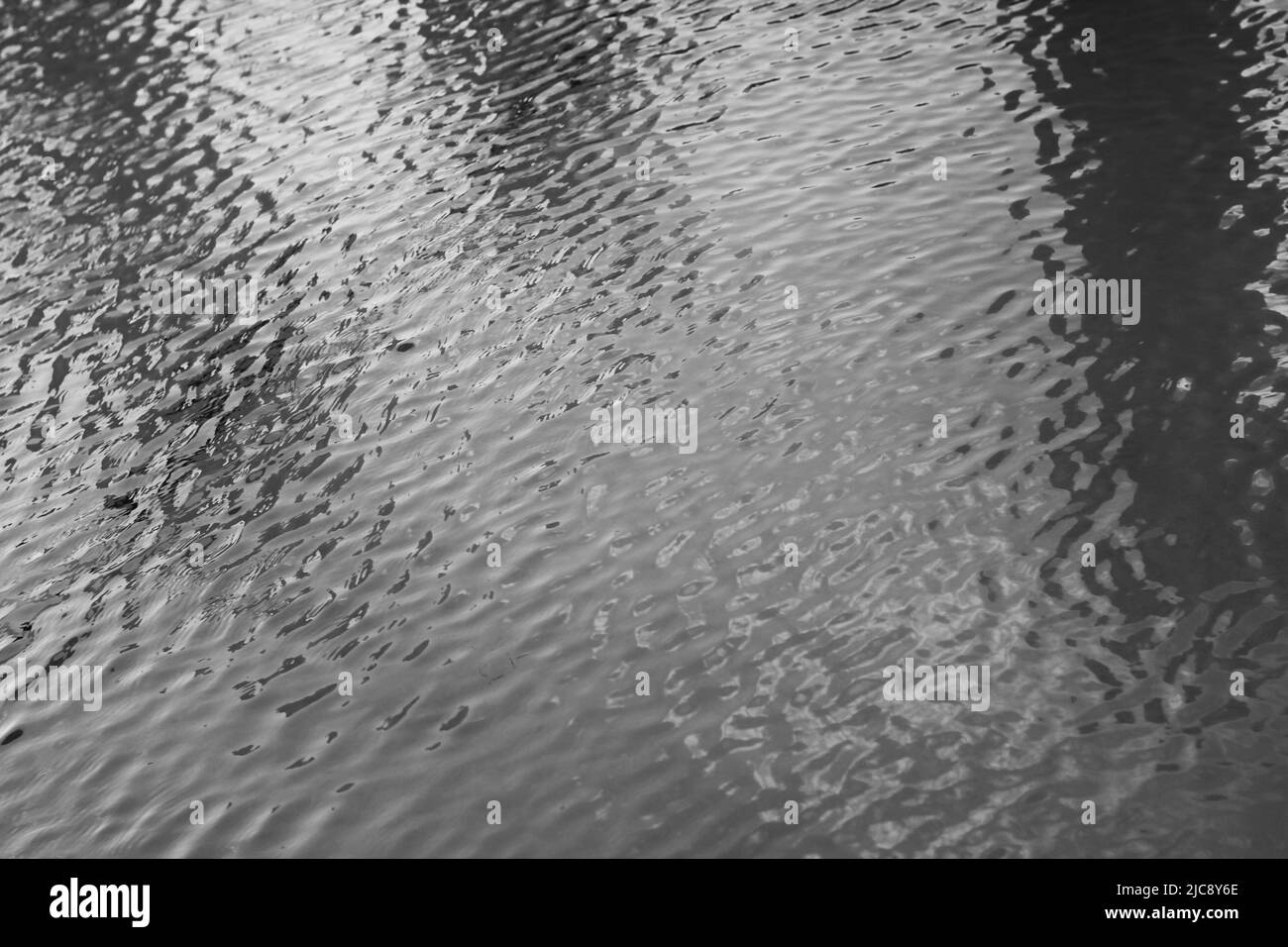 Simple and plain columns reflecting in the surface of the swimming pool ...