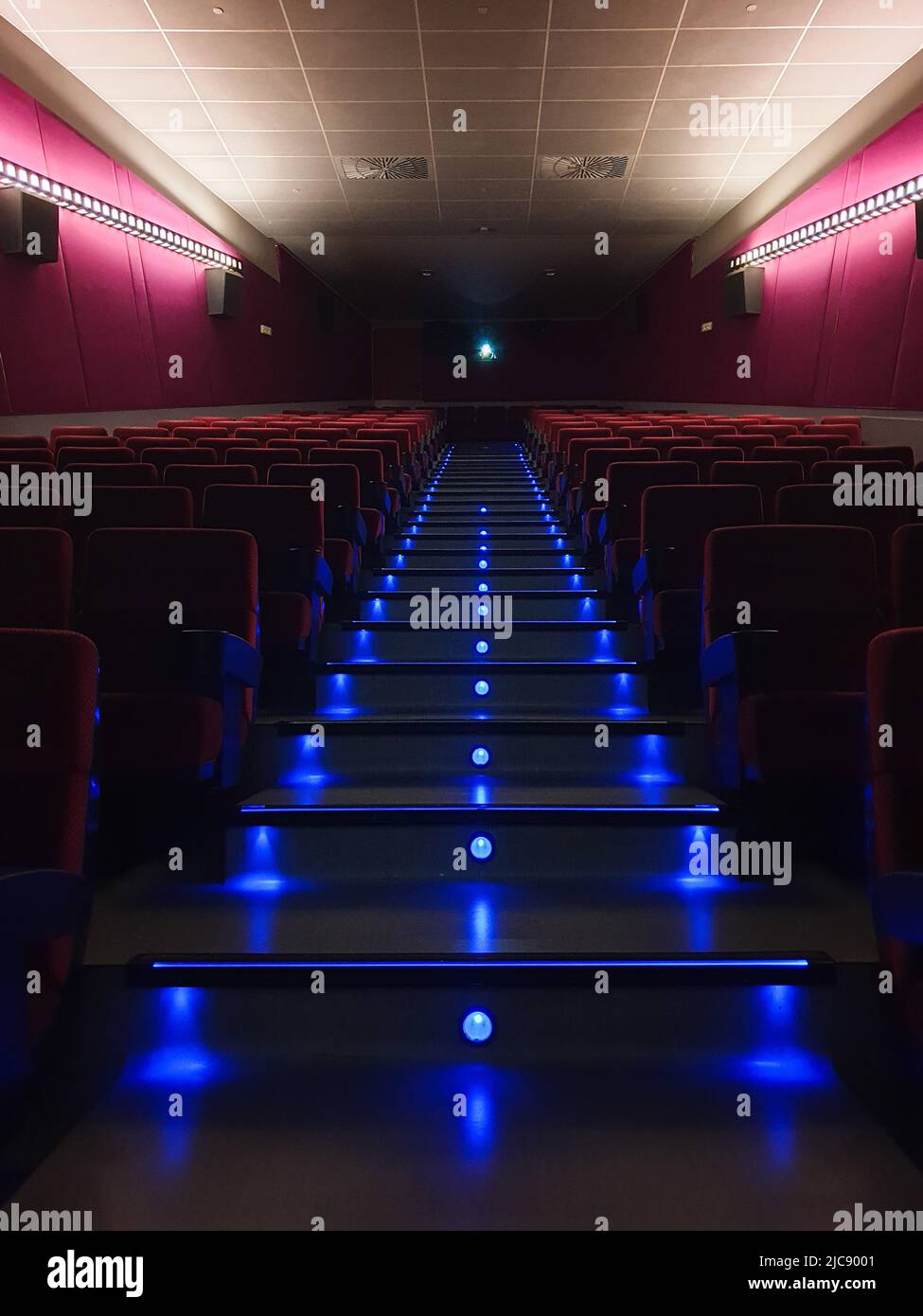 Empty cinema hall with stairs and blue light, no people Stock Photo - Alamy