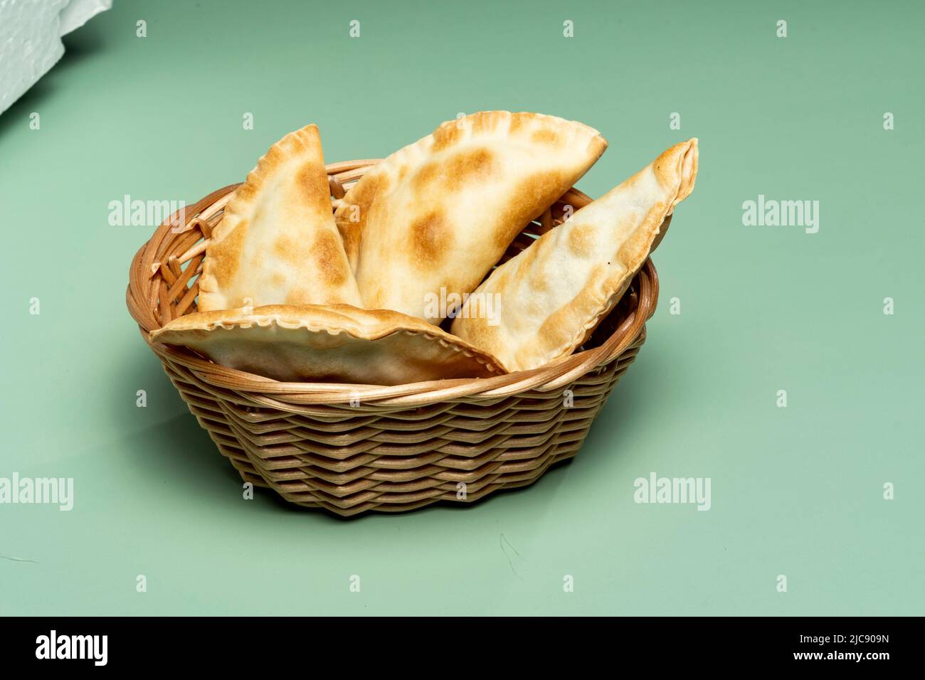 portion of bar meat pastries in a green background Stock Photo - Alamy