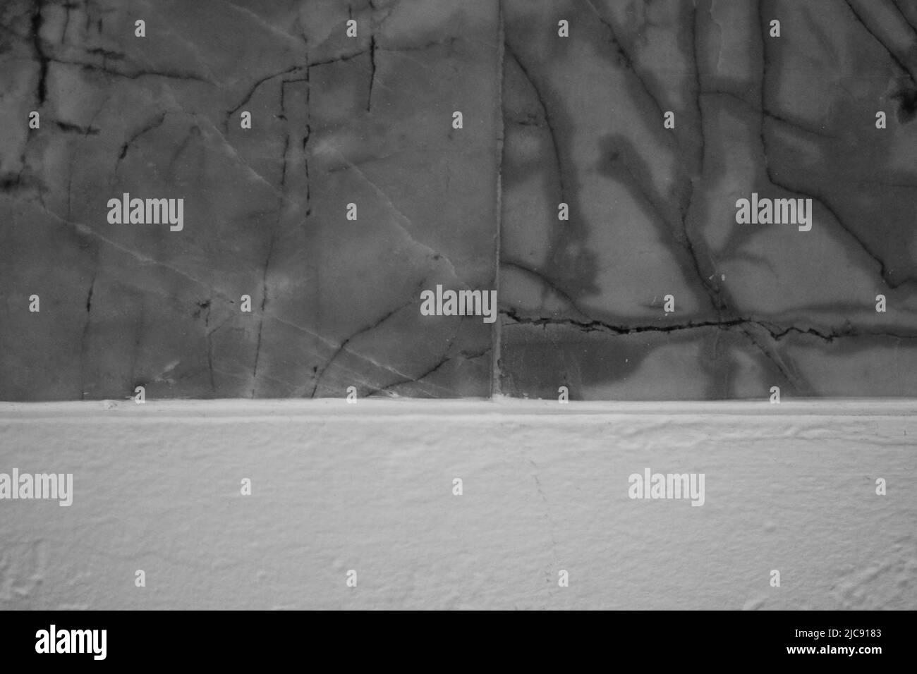 Minimalist view of aged marble tiles lining the floor in black and ...