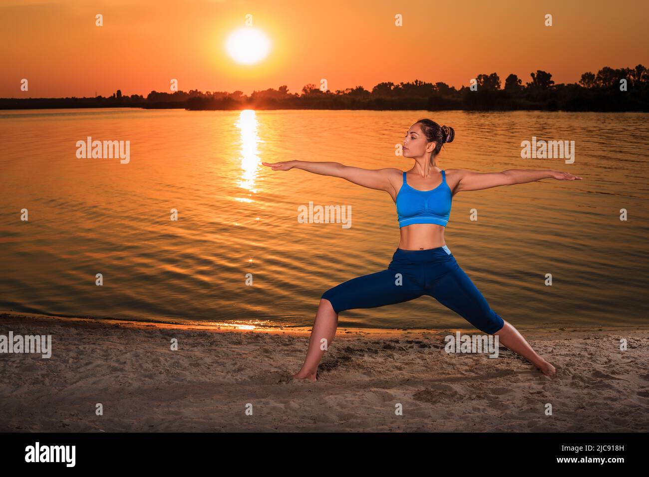 yoga at sunset on the beach Stock Photo - Alamy