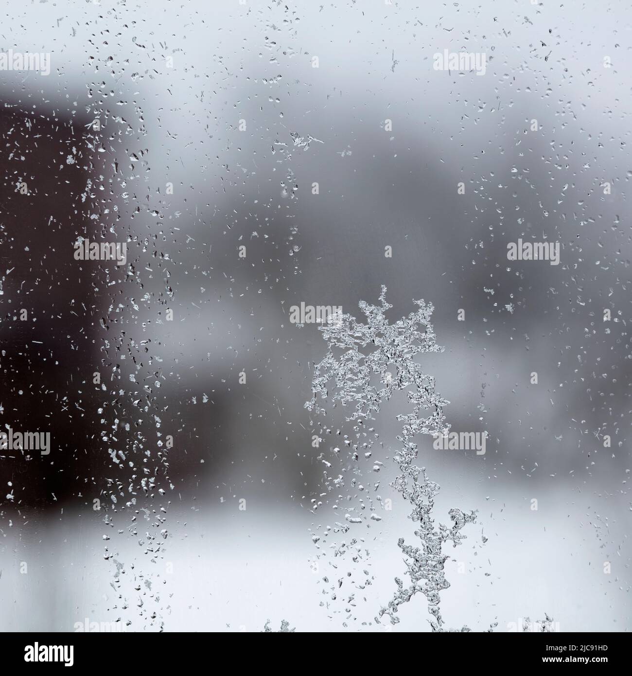 Snow and raindrops on a window. Fuzzy background Stock Photo - Alamy