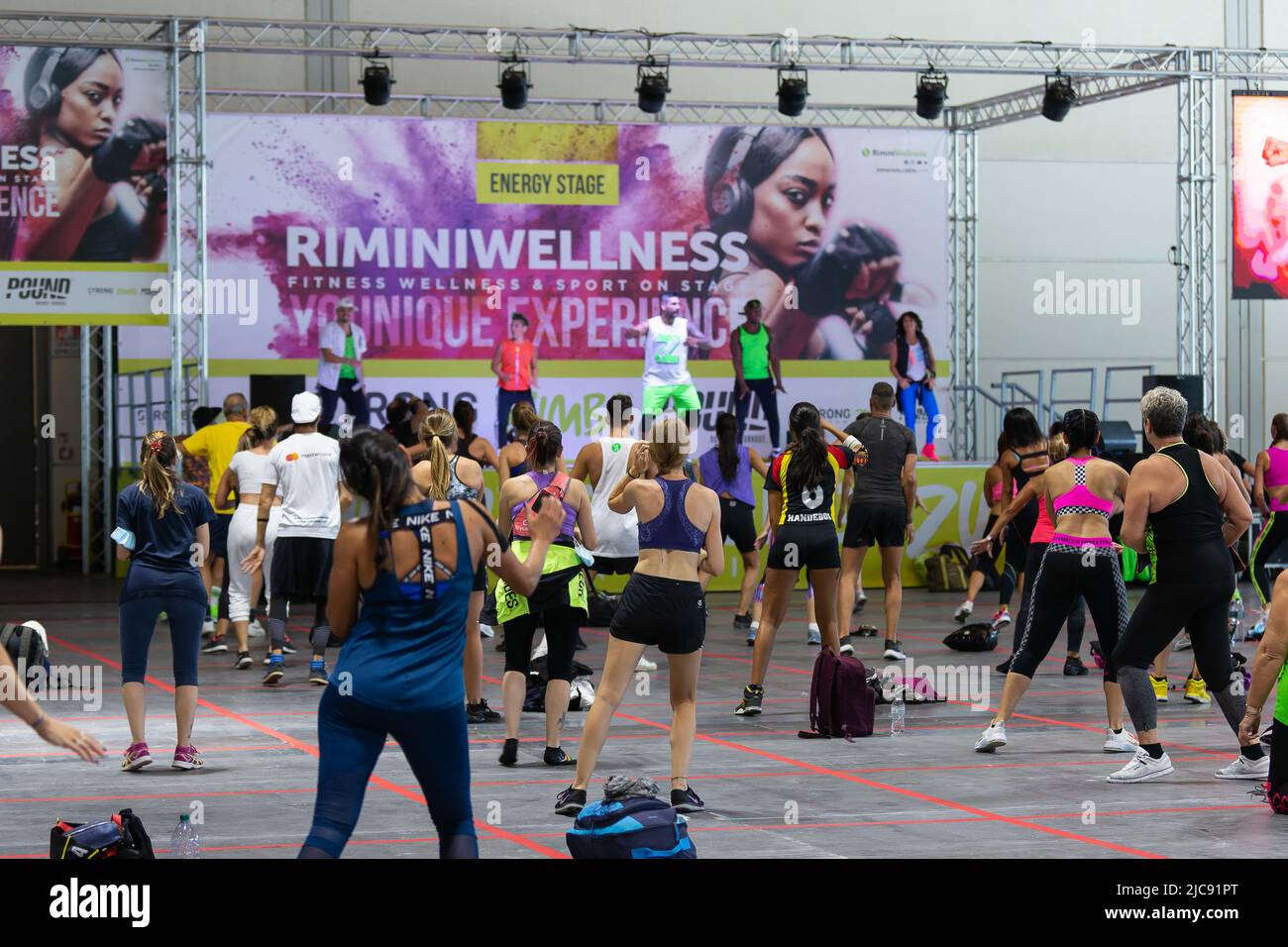 Fitness Workout in Gym: People doing Exercises in Class with Music and ...