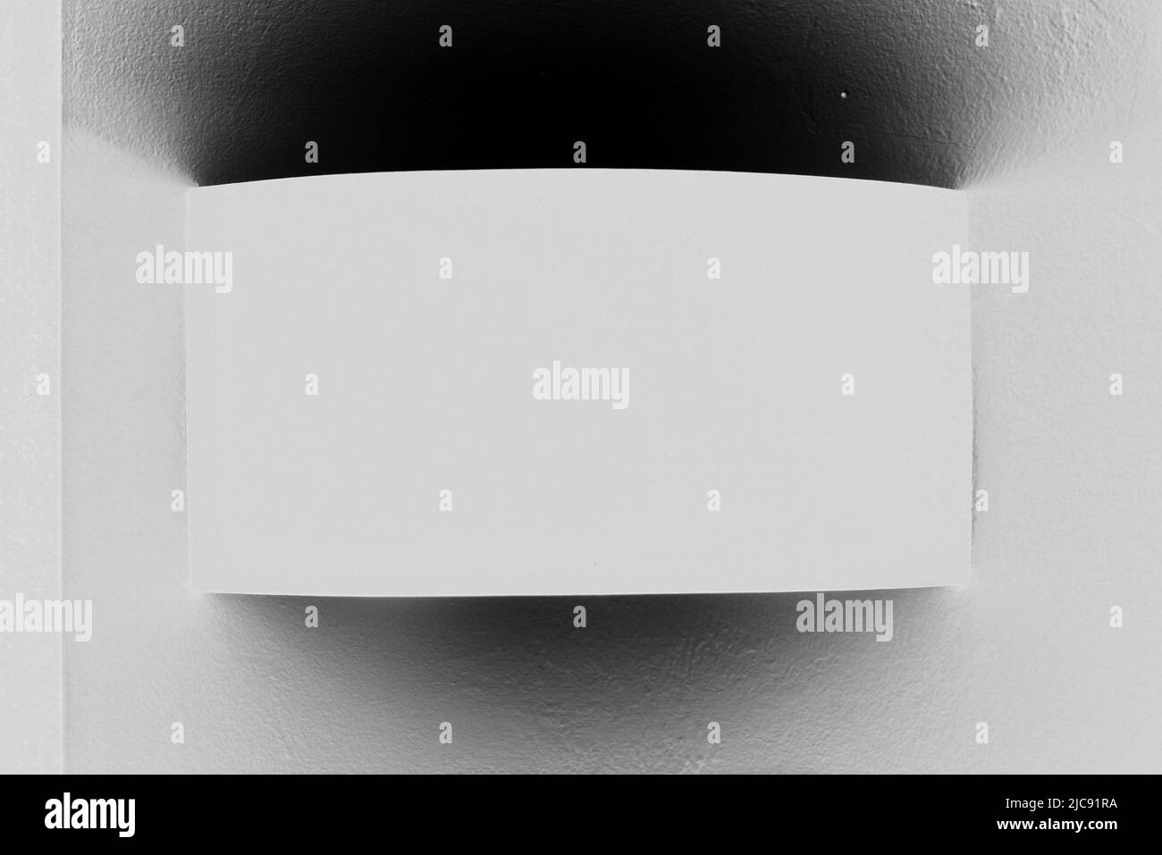 Simple plain lamp shade of a wall sconce in black and white film ...