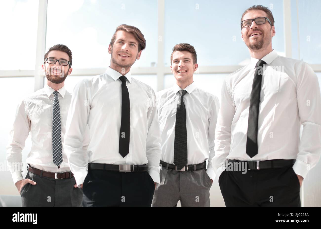 group of successful business people standing near the window Stock ...