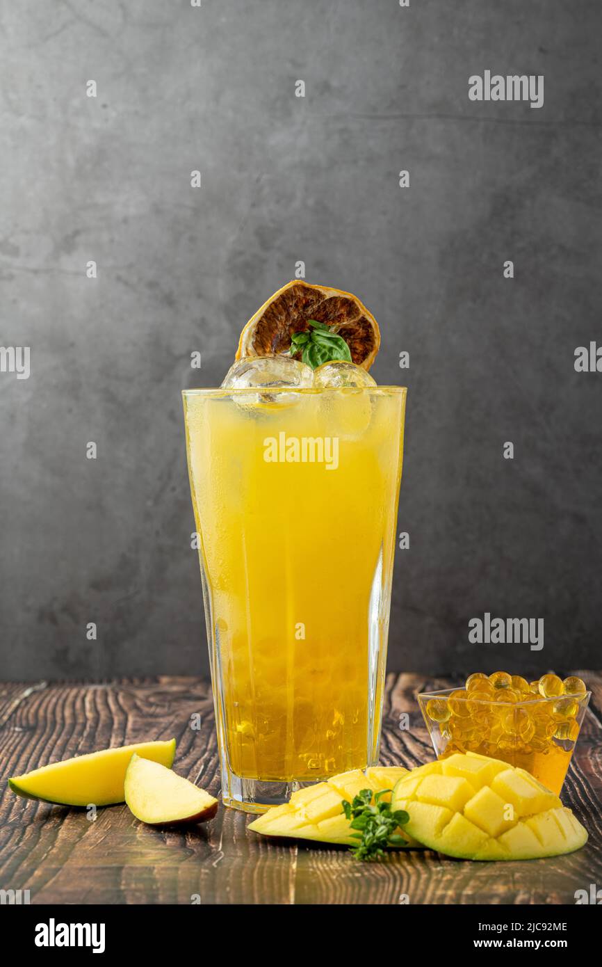 Mango lemonade with bubble tea on dark wooden background Stock Photo ...