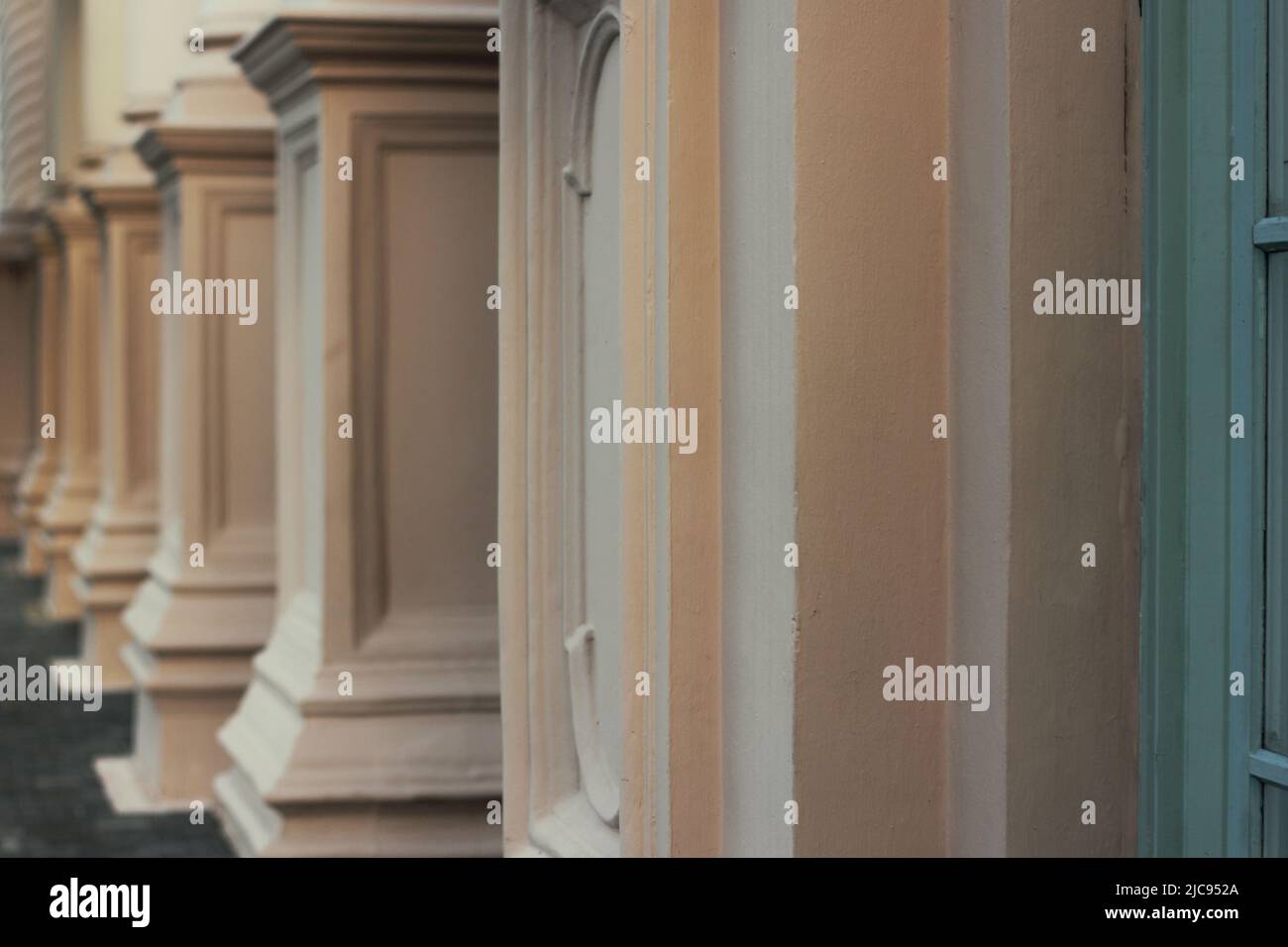 A colonnade of columns marching across the sidewalk Stock Photo - Alamy