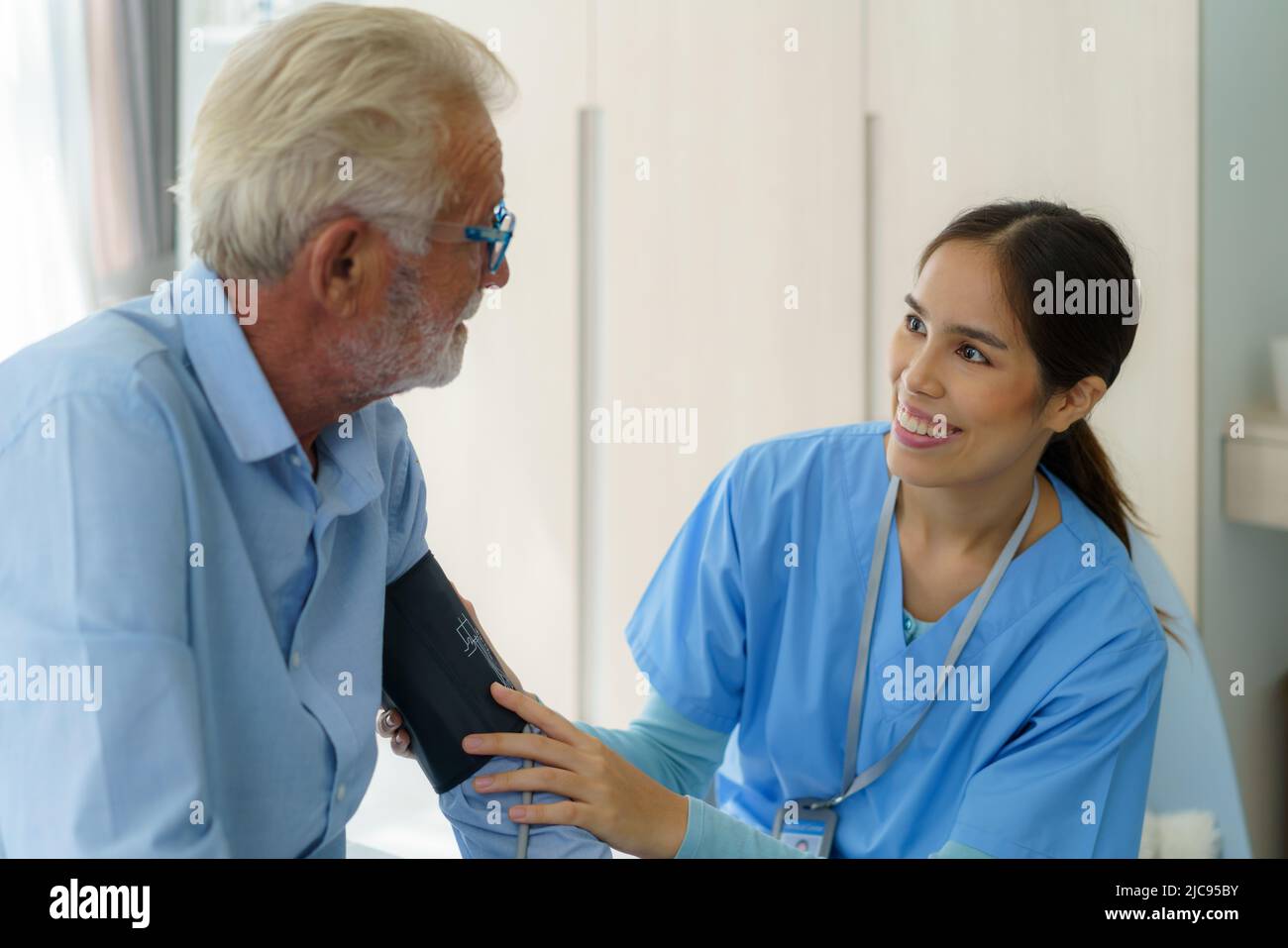 Doctor checking blood pressure patient using hi-res stock photography ...