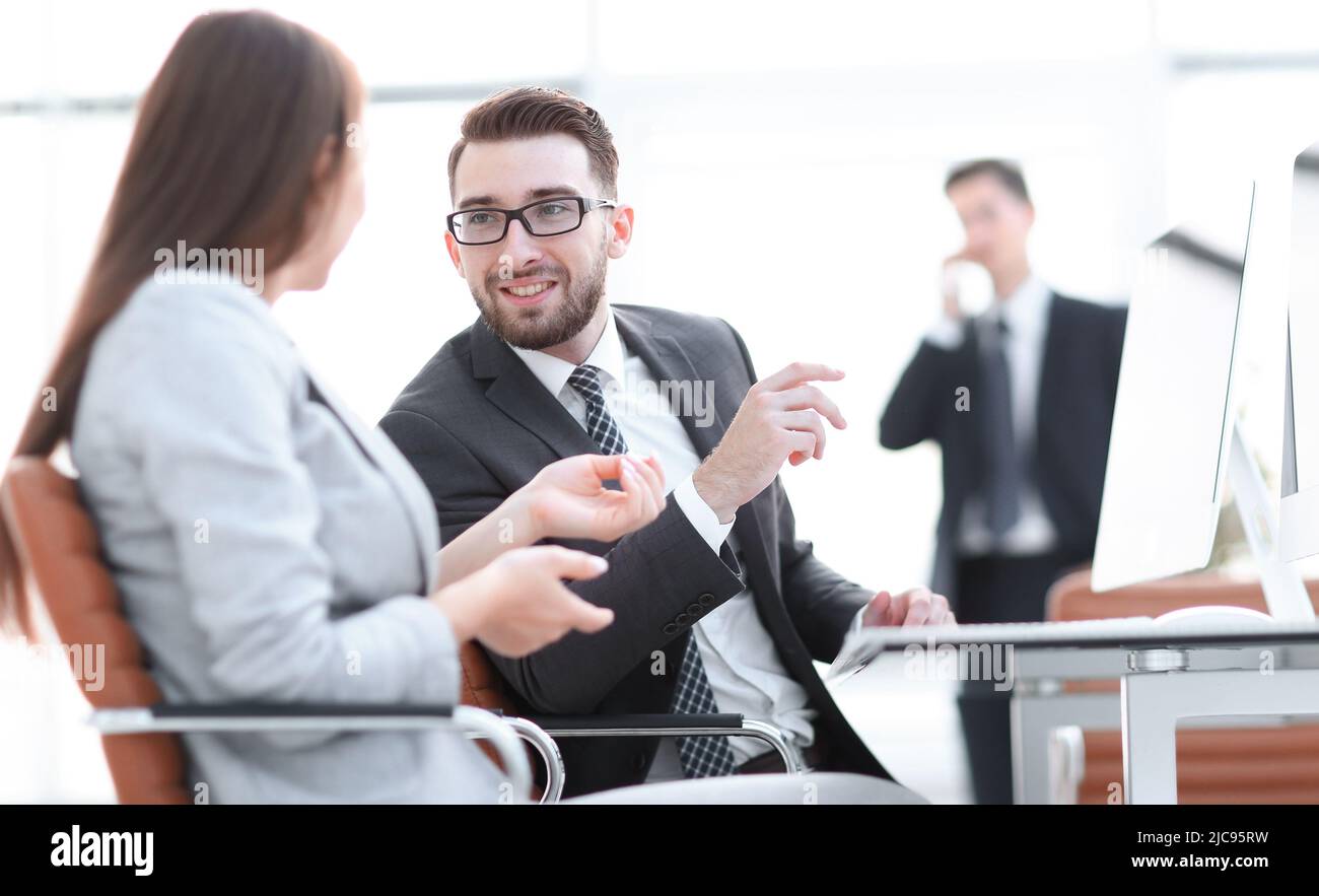 business colleagues talking at their Desk Stock Photo - Alamy