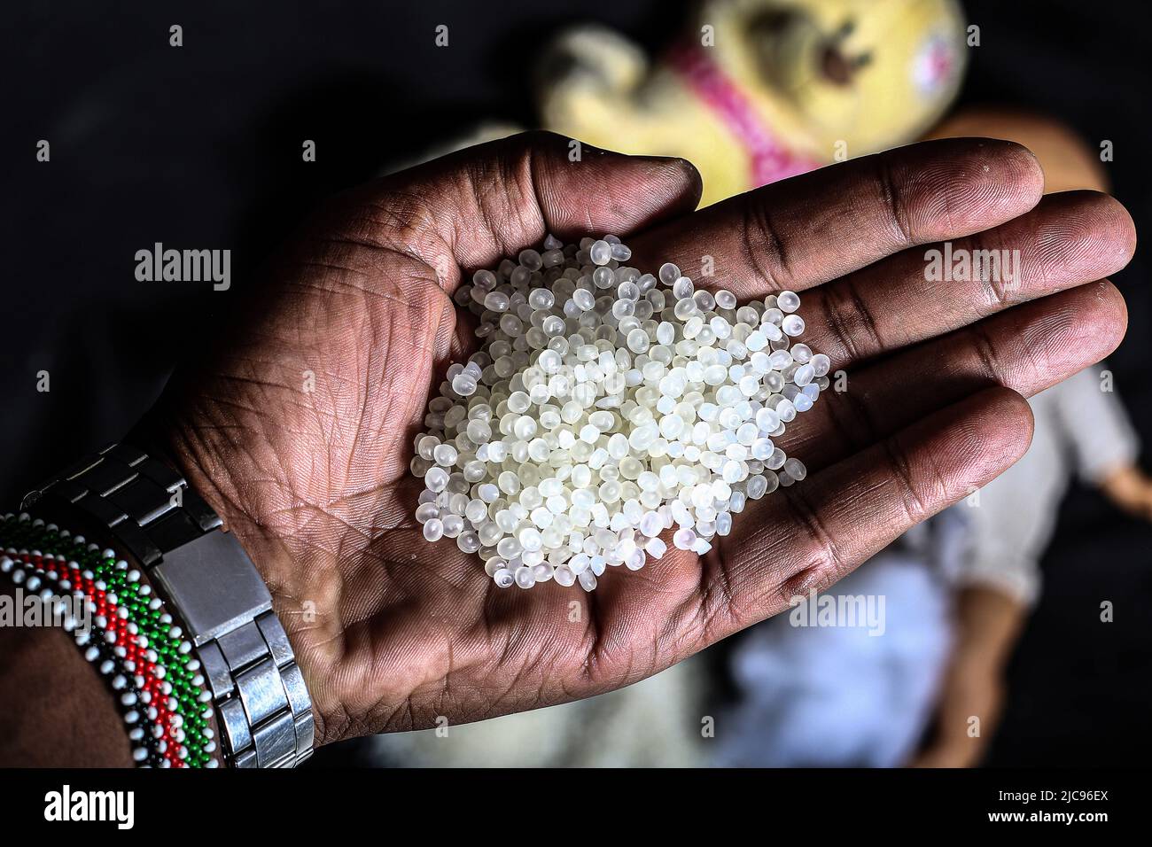 Nakuru, Kenya. 10th June, 2022. A man holds a handful of tiny plastic ...