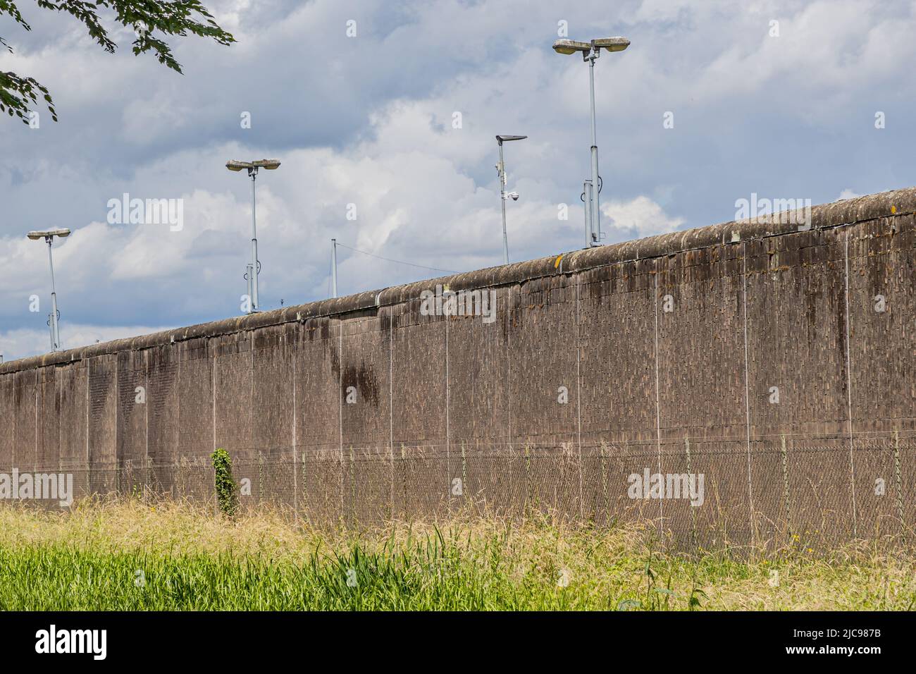 Huge thick high rise wall, tall pole lamps to light the place, wild ...