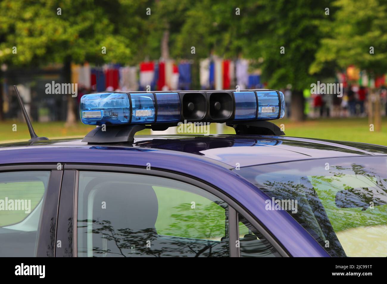 Blue sirens of police car during controlling in the public park during ...