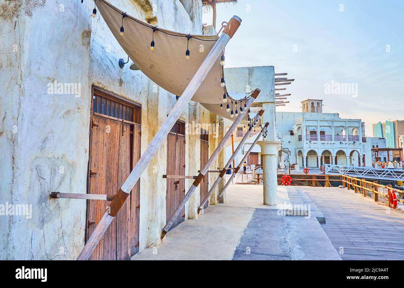 Embankment of Dubai Creek with a view of traditional adobe houses ...