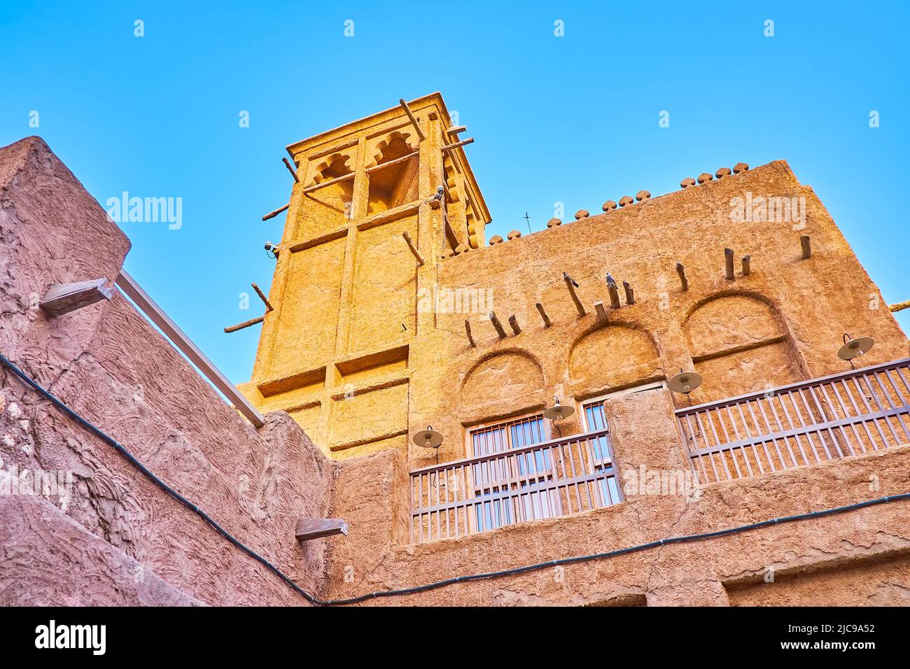 The upper floor of traditional Arabic adobe house with barjeel ...