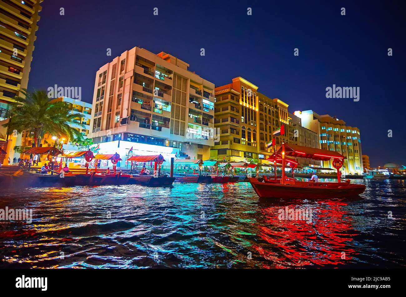 The evening cityscape of Bur Dubai from Dubai Creek with a view on ...