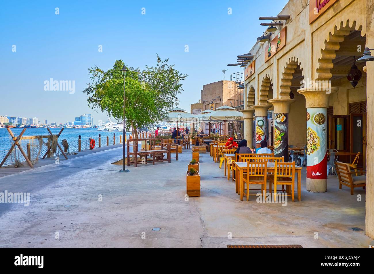 DUBAI, UAE - MARCH 1, 2020: The bank of Al Seef neighborhood with line of tourist cafes and ...